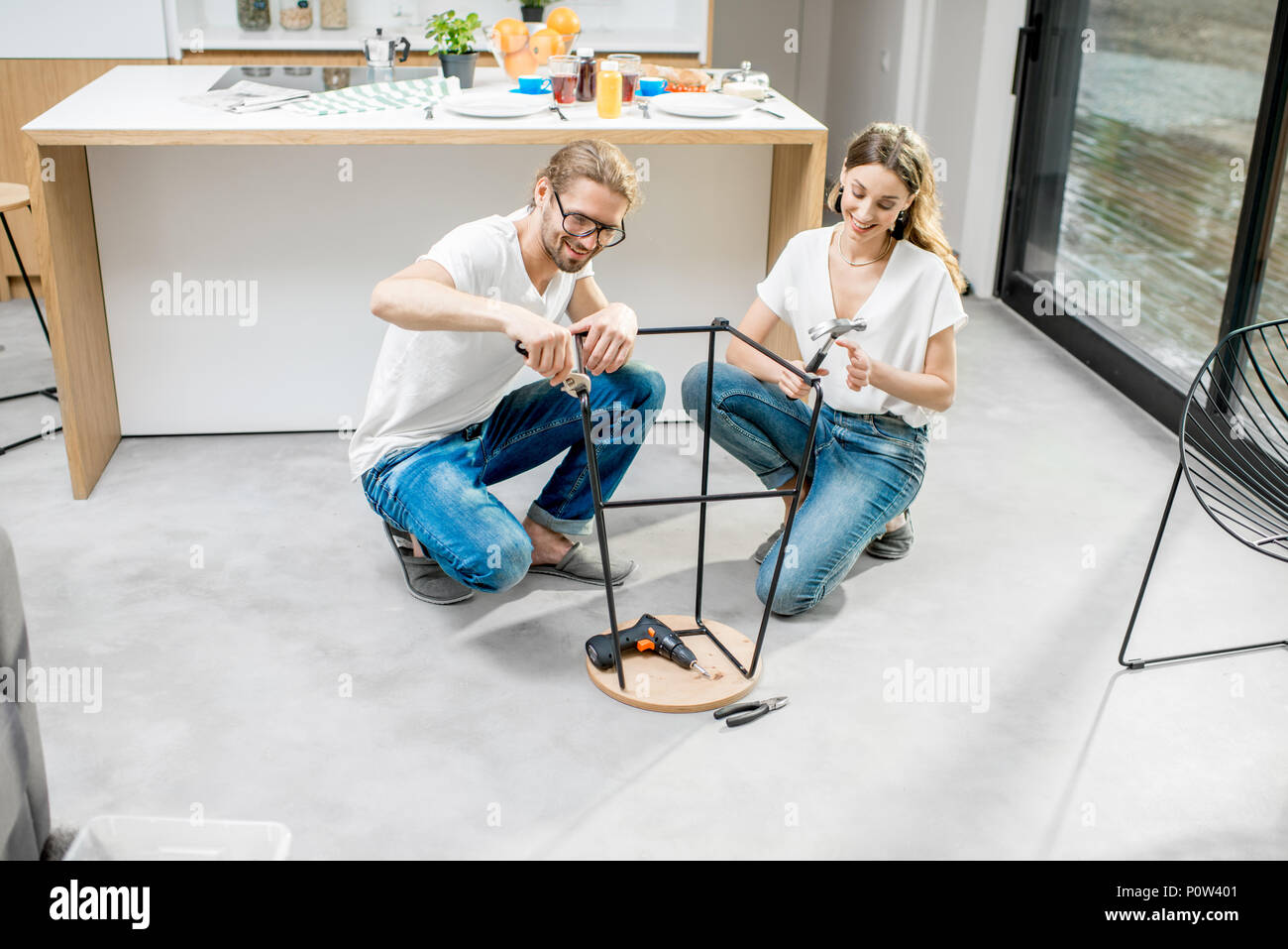 Couple doing house chores at the modern apartment Stock Photo - Alamy