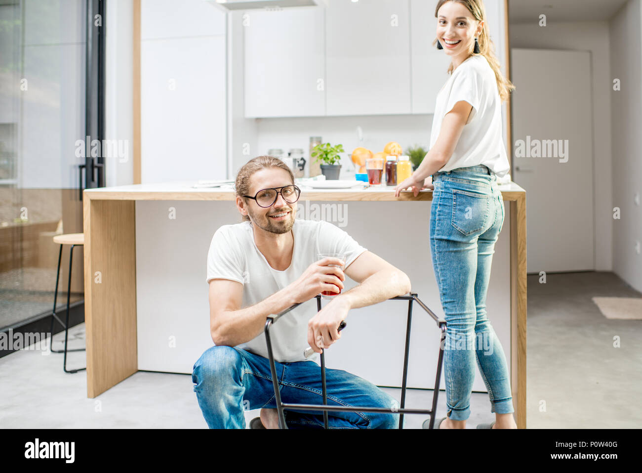 Couple doing house chores at the modern apartment Stock Photo - Alamy