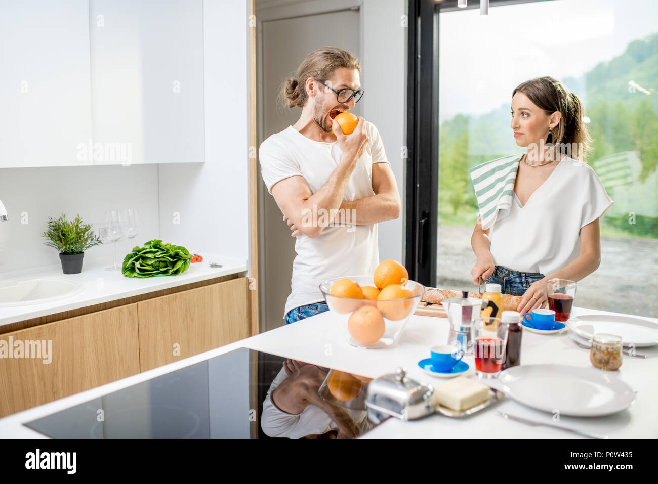 Young couple having breakfast at home Stock Photo - Alamy