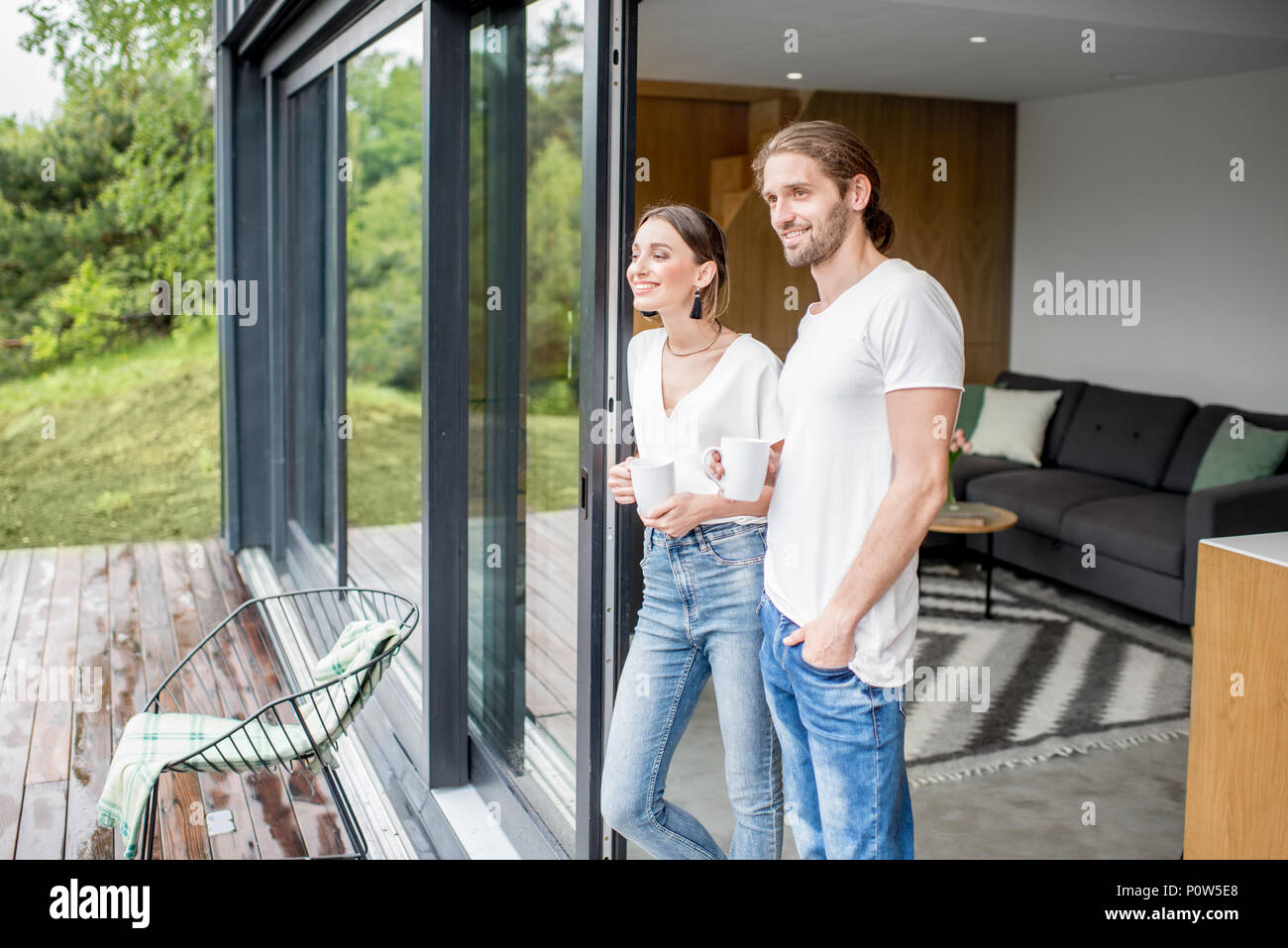 Couple on the terrace of the modern house Stock Photo - Alamy
