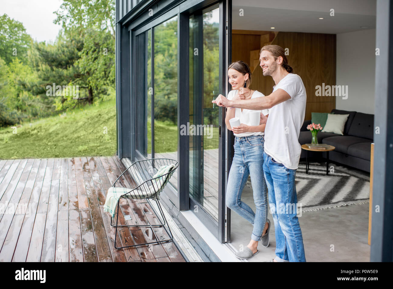 Couple on the terrace of the modern house Stock Photo - Alamy