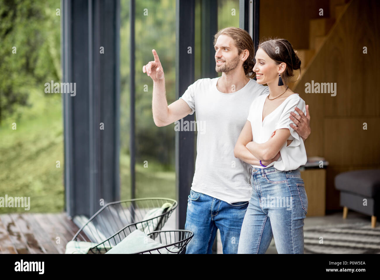 Couple on the terrace of the modern house Stock Photo - Alamy