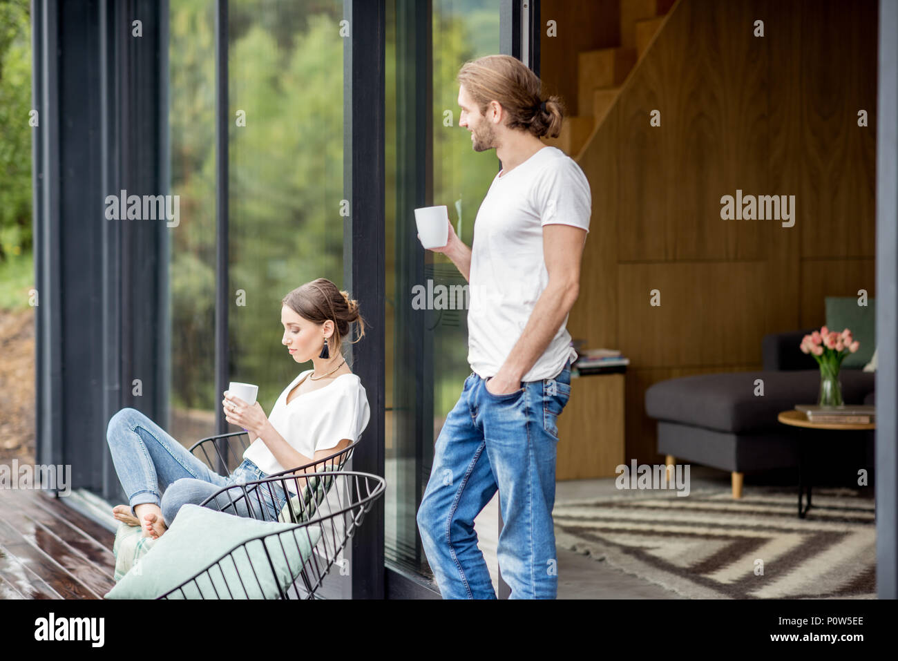 Couple on the terrace of the modern house Stock Photo - Alamy