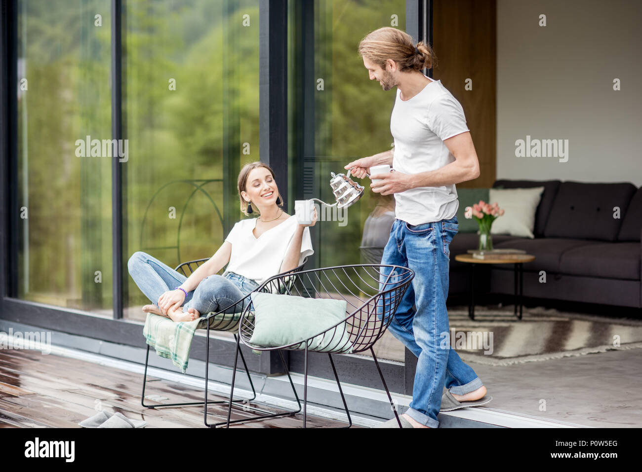 Couple on the terrace of the modern house Stock Photo - Alamy