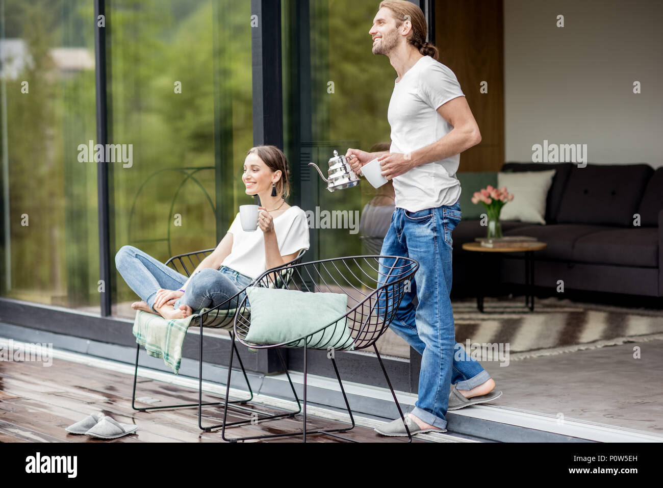 Couple on the terrace of the modern house Stock Photo - Alamy