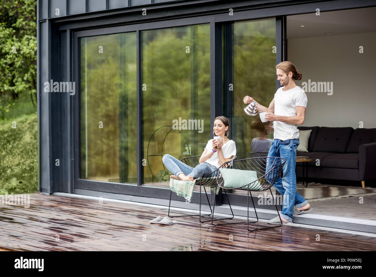 Couple on the terrace of the modern house Stock Photo - Alamy