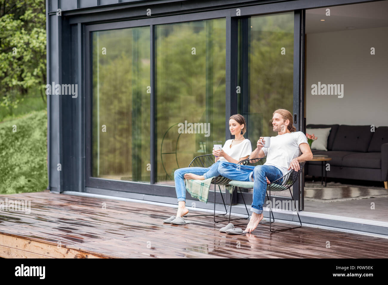 Couple on the terrace of the modern house Stock Photo - Alamy