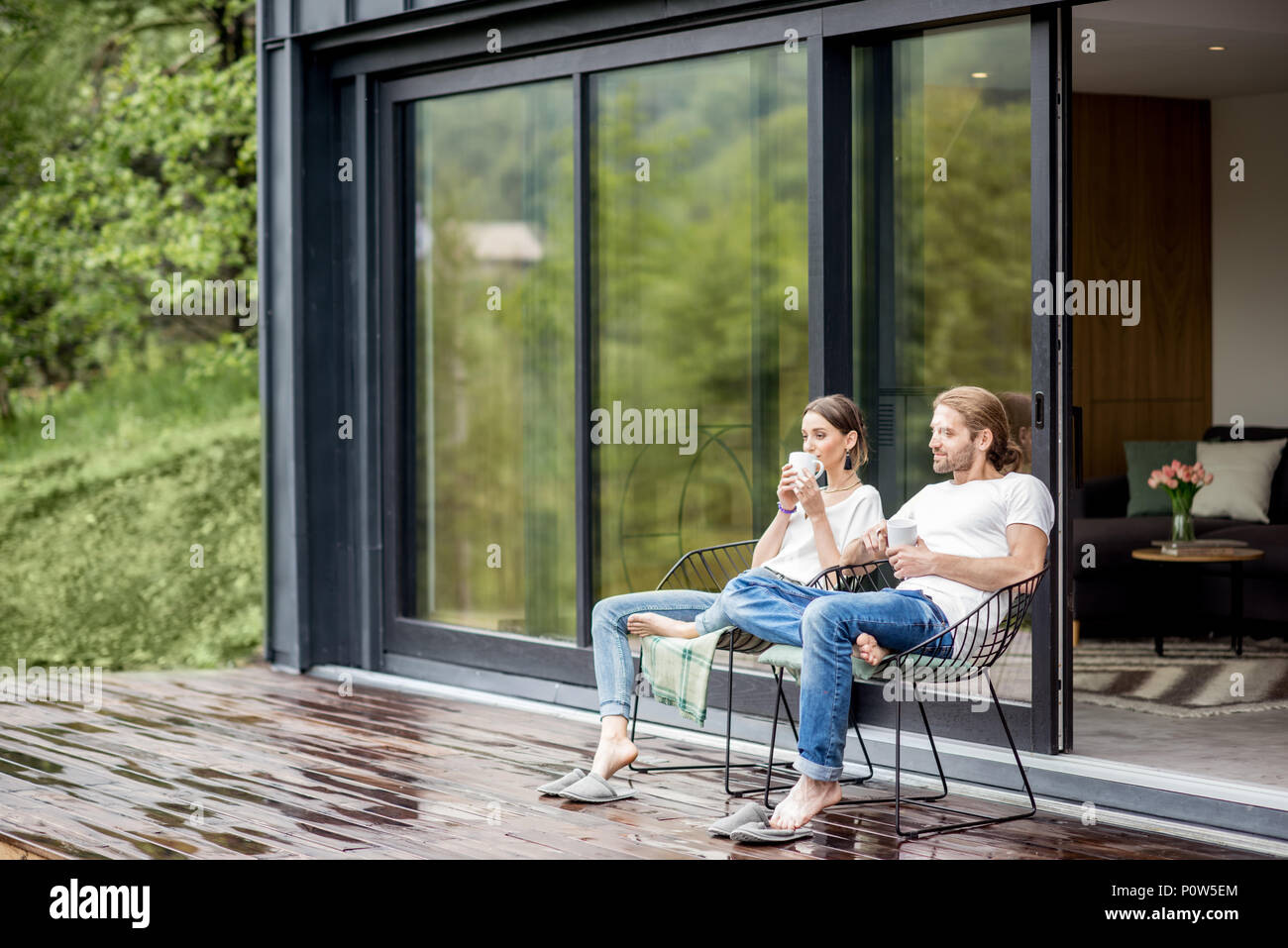 Couple on the terrace of the modern house Stock Photo - Alamy