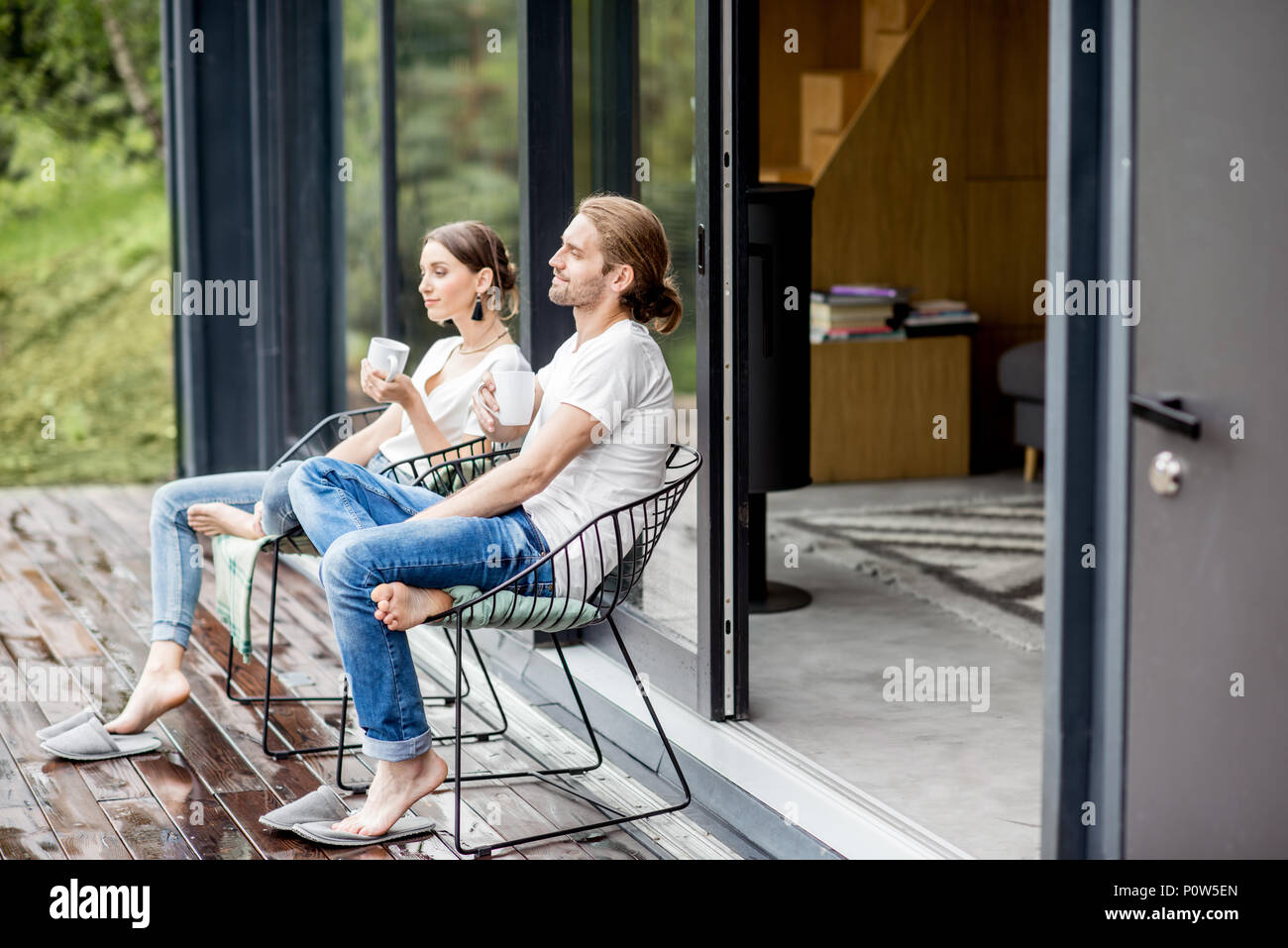Couple on the terrace of the modern house Stock Photo - Alamy
