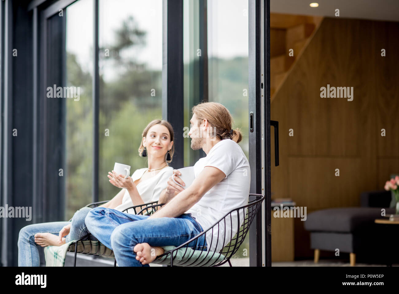 Couple on the terrace of the modern house Stock Photo - Alamy