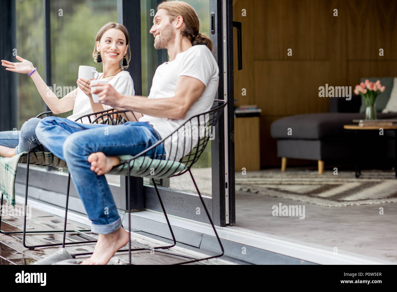 Couple on the terrace of the modern house Stock Photo - Alamy