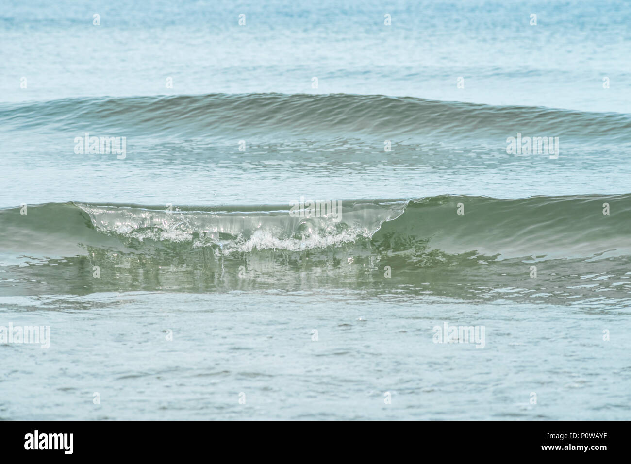 calm sea surf formation, focus on front wave Stock Photo - Alamy