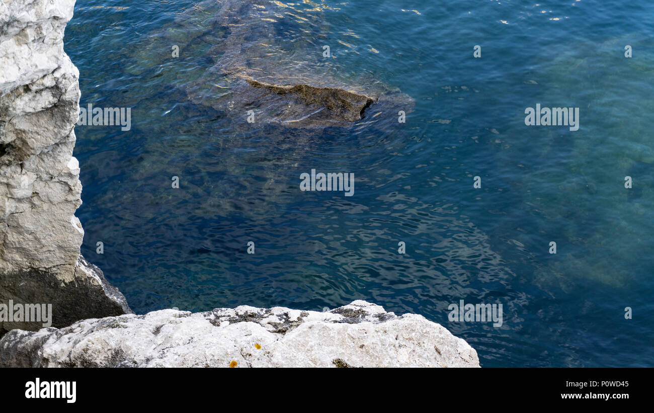 Clear and crystalline sea with white rocks Stock Photo - Alamy