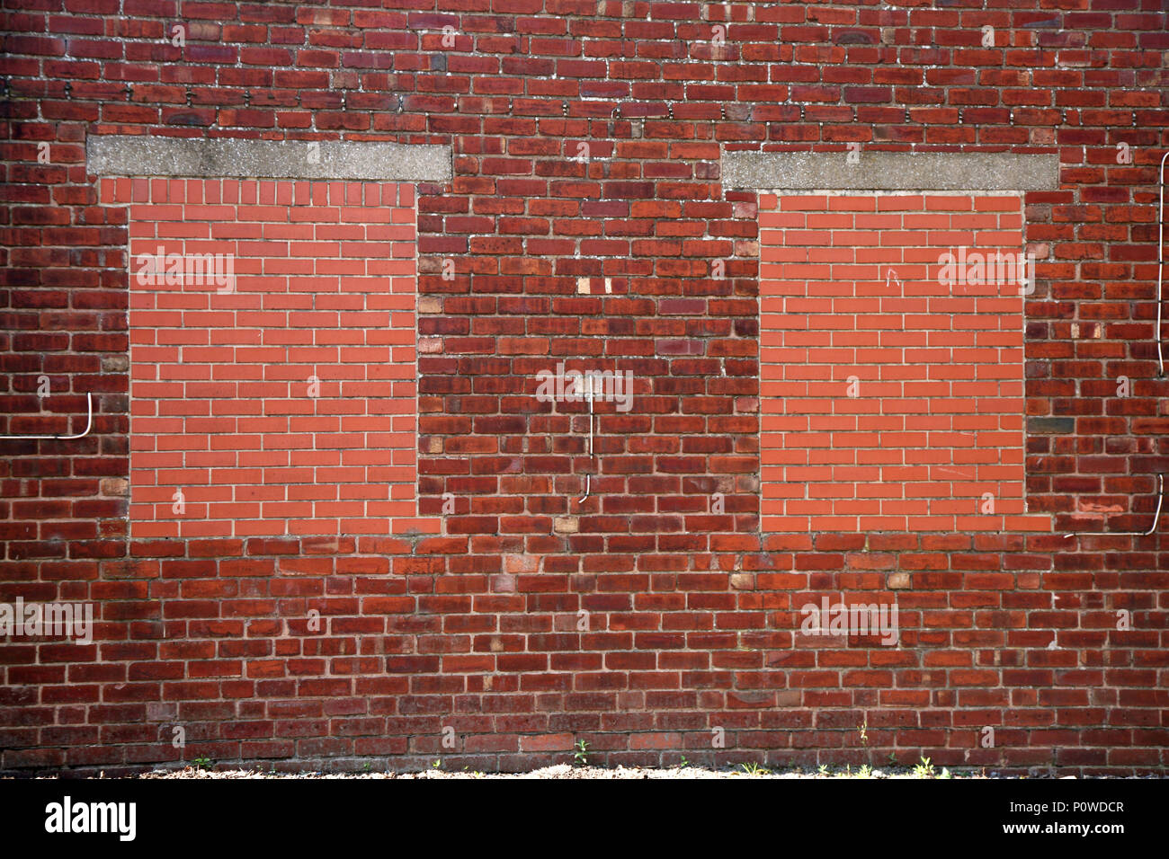 A bricked up red wall on old building in Dinnington, Sheffield, South ...
