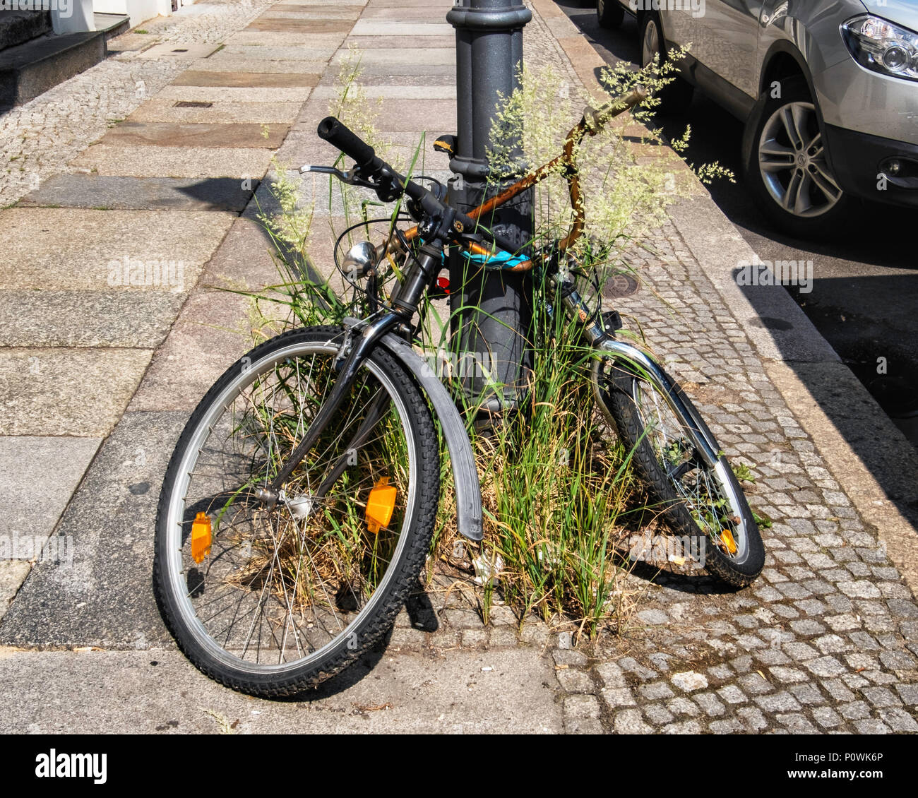 Berlin, Mitte. Abandoned, disused bicycles left to rust on city ...