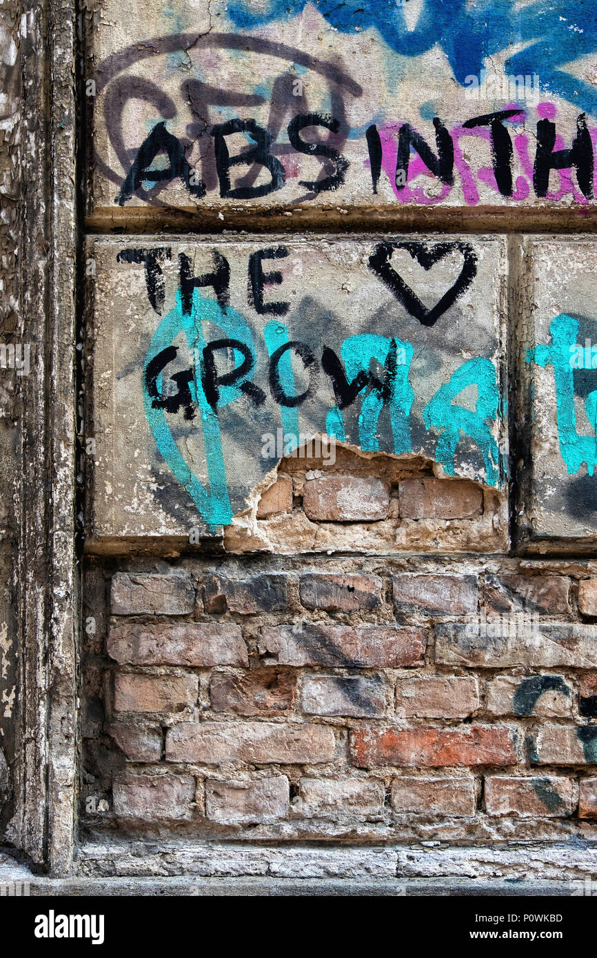 berlin. Decrepit weathered old wall with exposed bricks and amusing ...