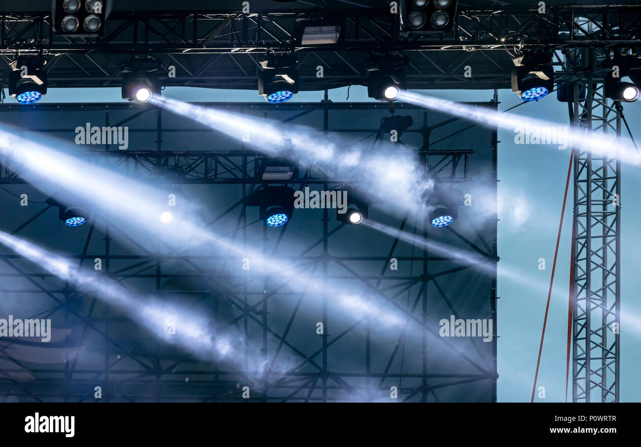 outdoor stage view. lightning equipment, blue searchlights during ...