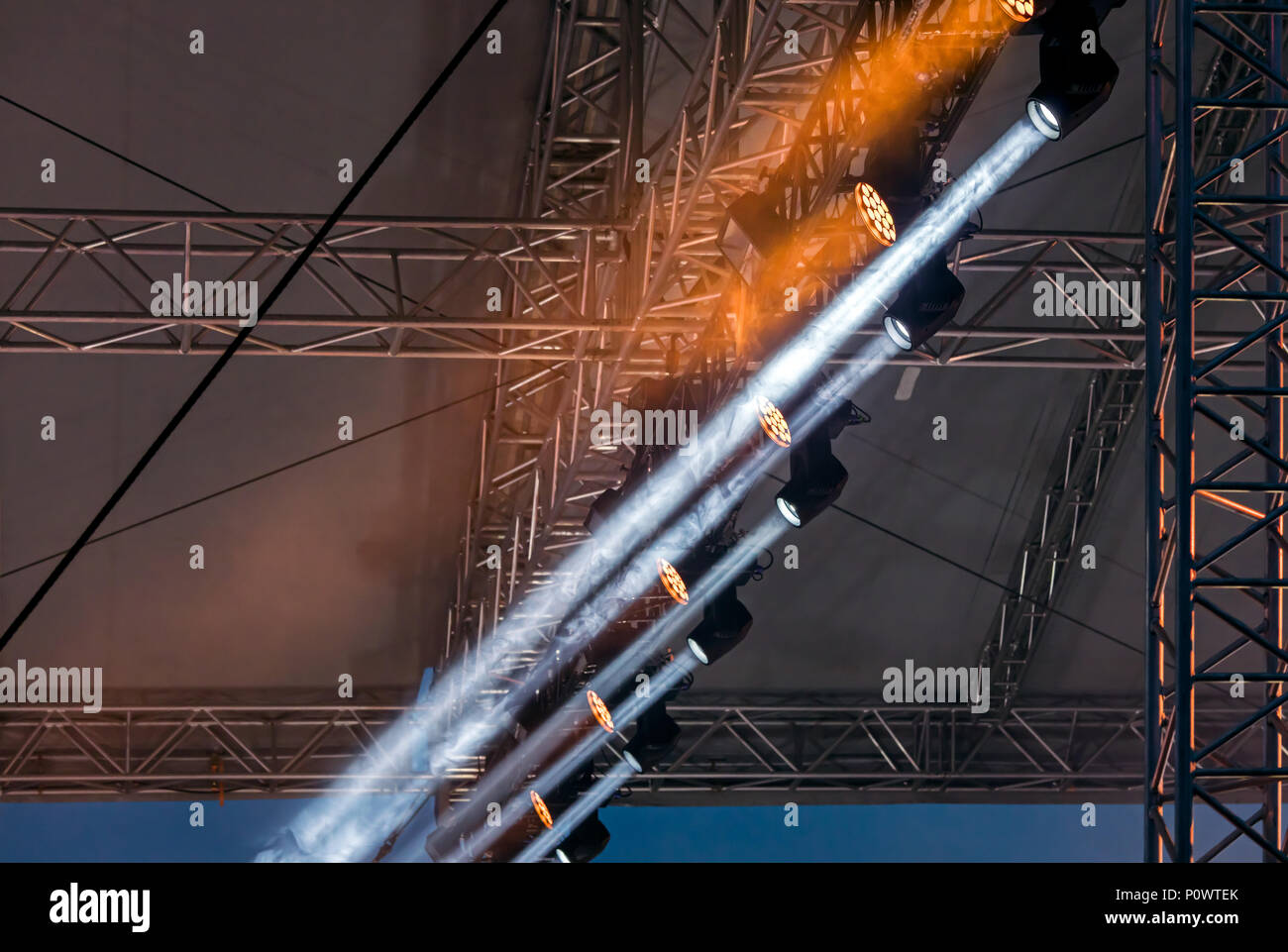 concert lightning equipment. yellow and white rays of spotlights on ...