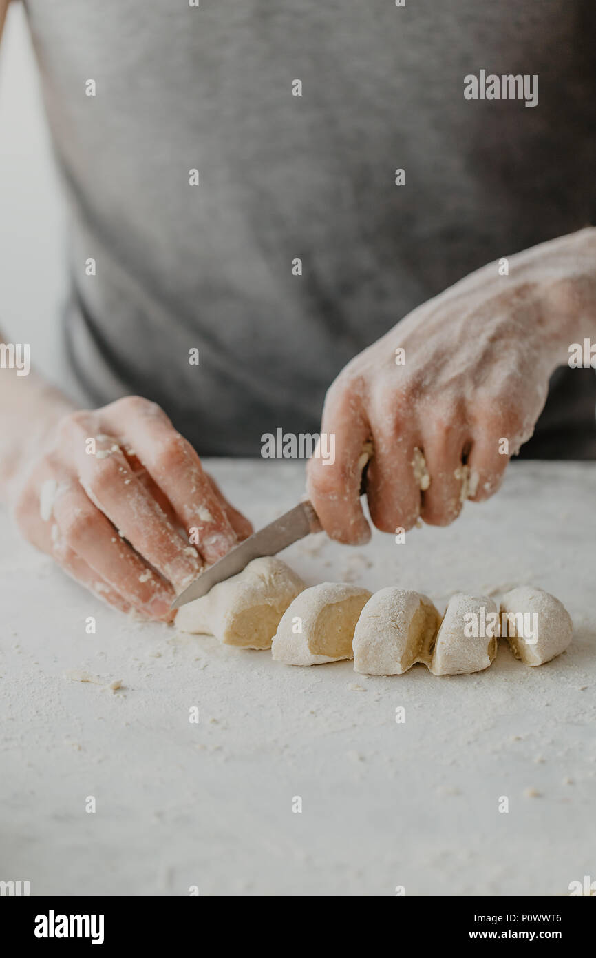 Process of cutting dough making dish cooking homemade dough. Chef makes ...