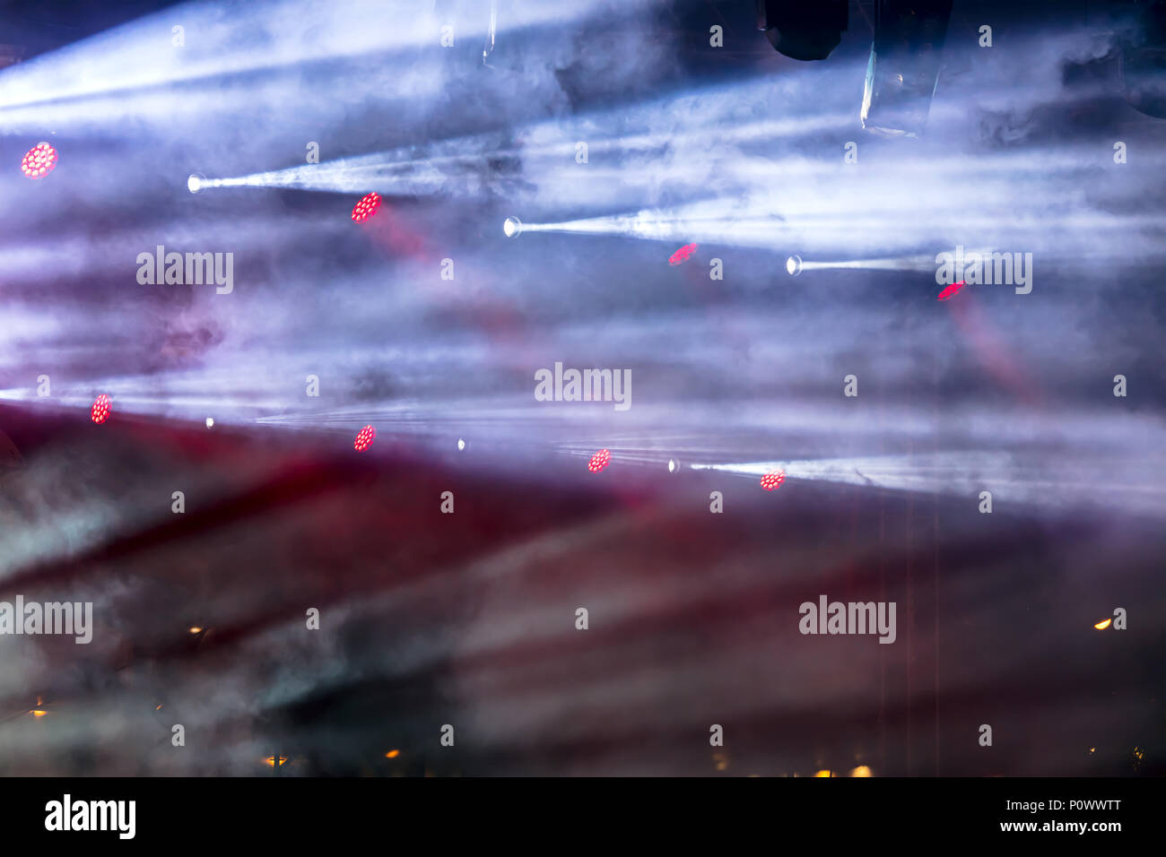 stage lights during outdoor performance in a haze with blue backlight ...