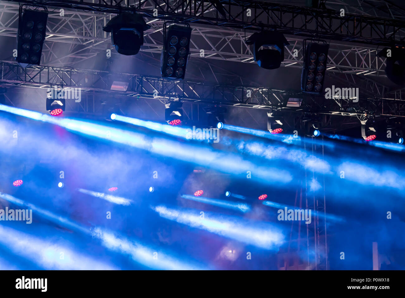 professional stage equipment. blue searchlights and smoke on outdoor ...