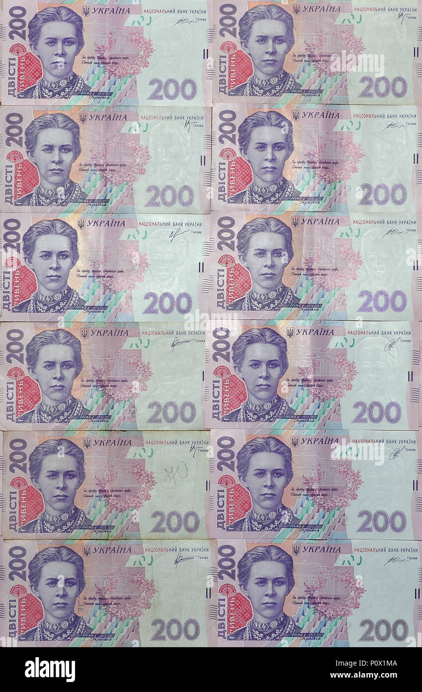 A close-up of a pattern of many Ukrainian currency banknotes with a par ...