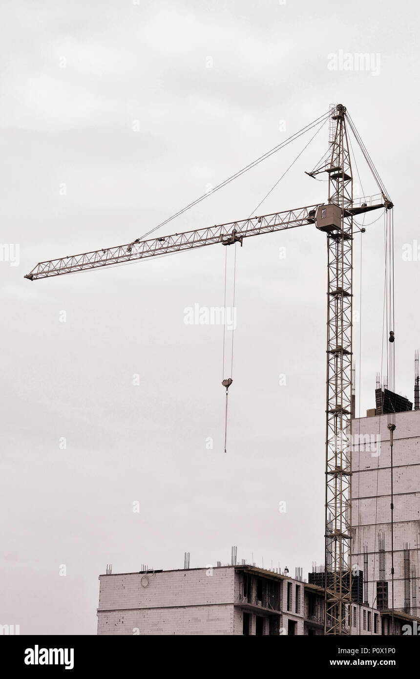 Working tall cranes inside place for with tall buildings under ...