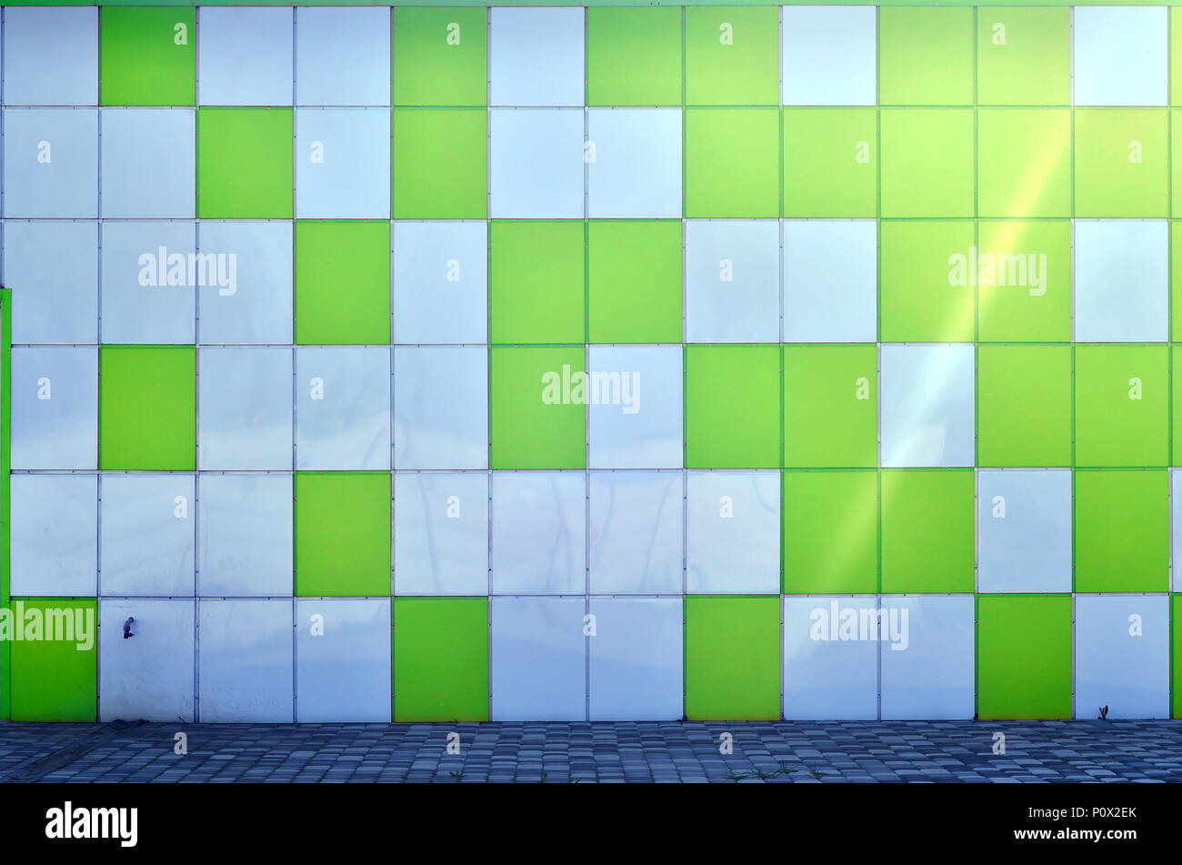 The texture of the metal wall, framed in the form of colored squares of ...