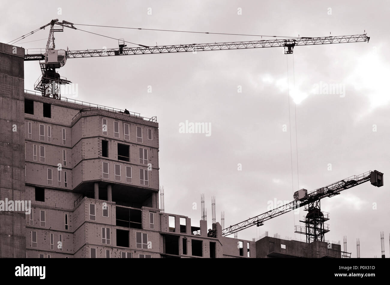 Working tall cranes inside place for with tall buildings under ...