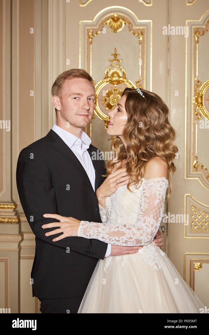Wedding Couple Indoors Is Hugging Each Other Beautiful Model Girl In White Dress Man In Suit