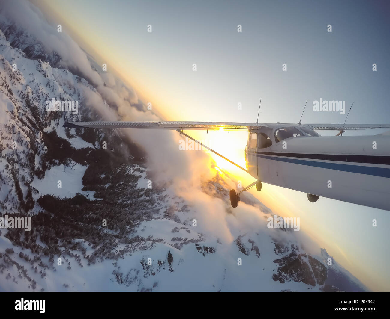 Airplane flying over the beautiful Canadian Landscape during a vibrant ...