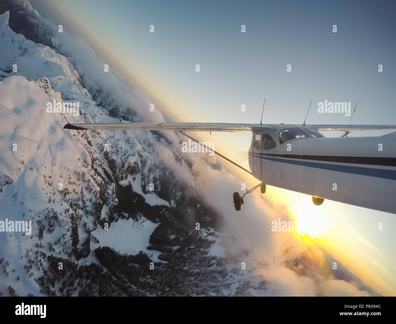 Airplane flying over the beautiful Canadian Landscape during a vibrant ...