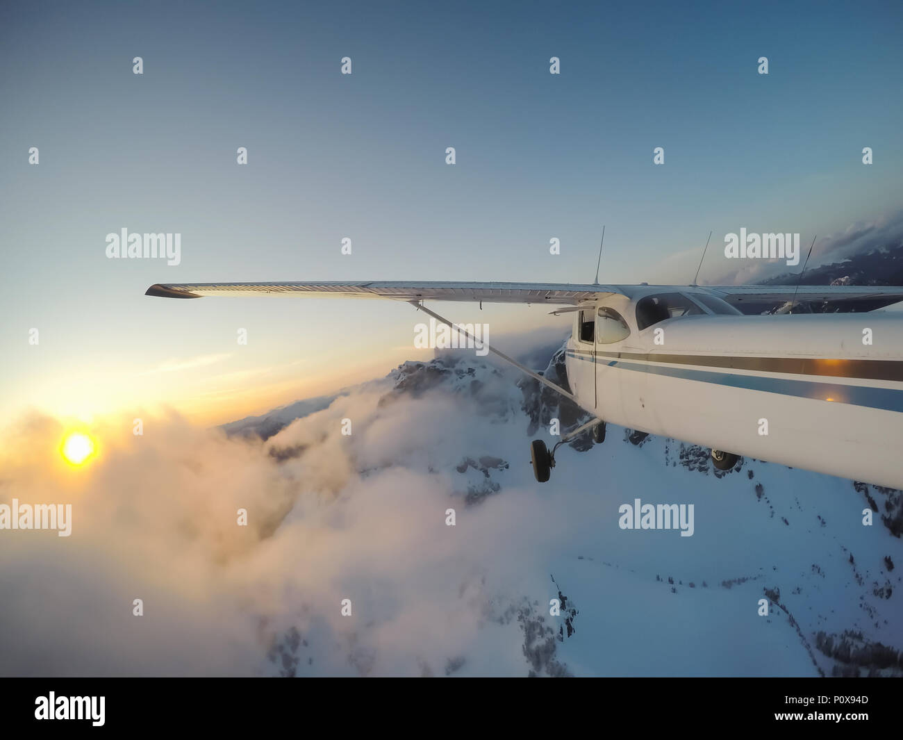 Airplane flying over the beautiful Canadian Landscape during a vibrant ...