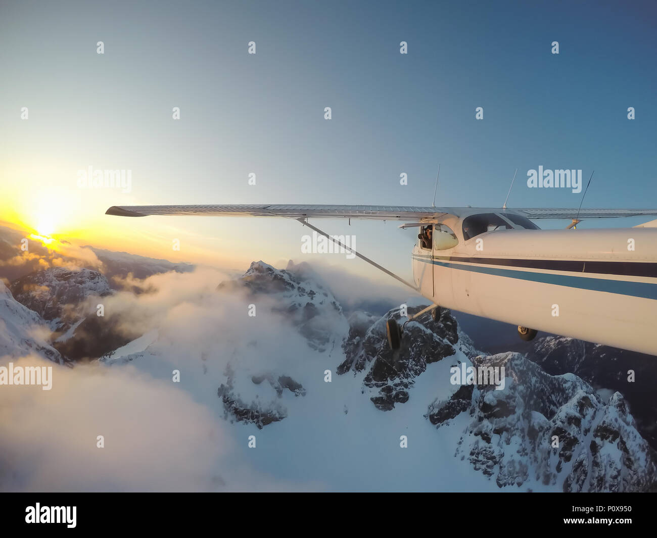 Airplane flying over the beautiful Canadian Landscape during a vibrant ...