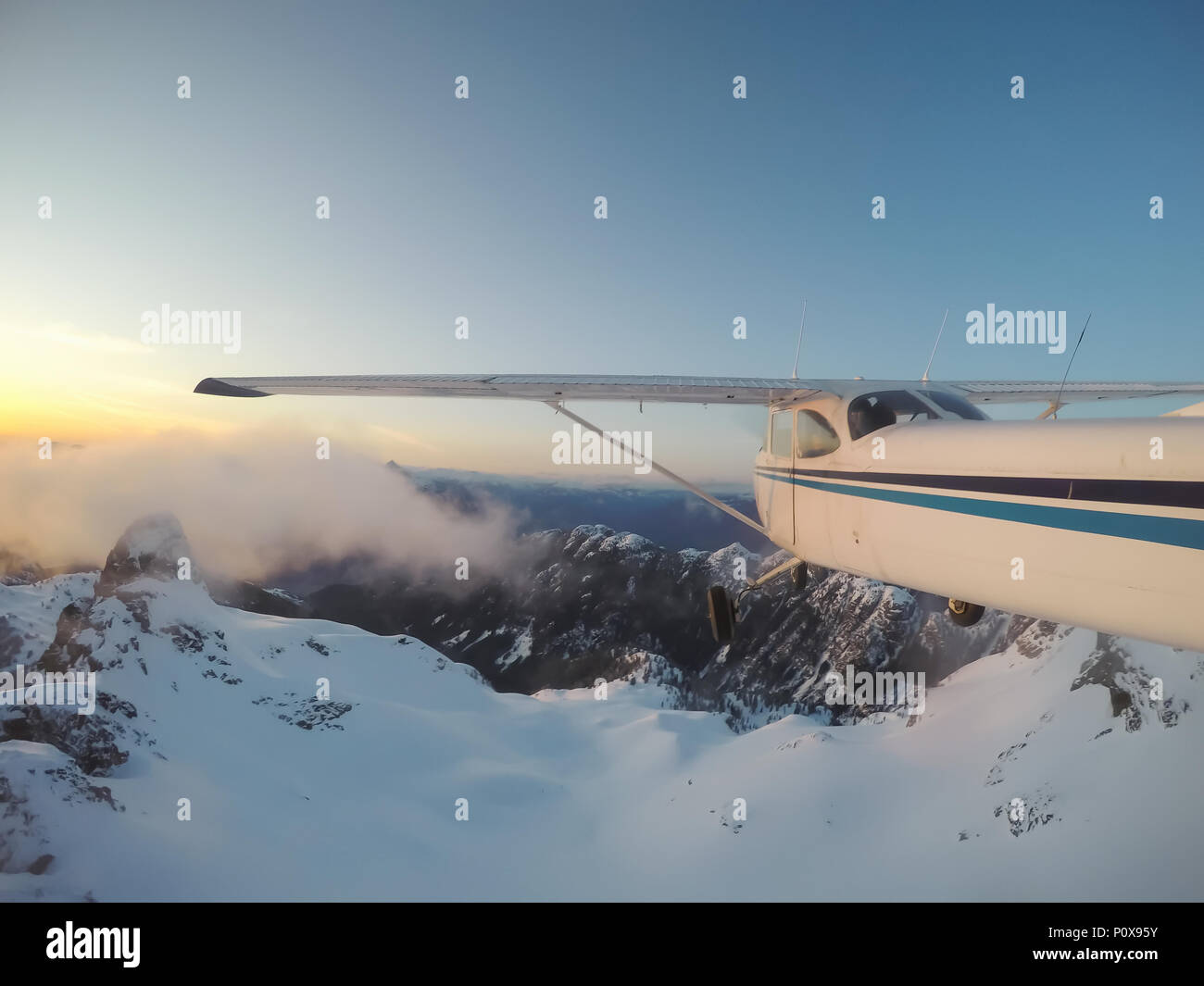 Airplane flying over the beautiful Canadian Landscape during a vibrant ...