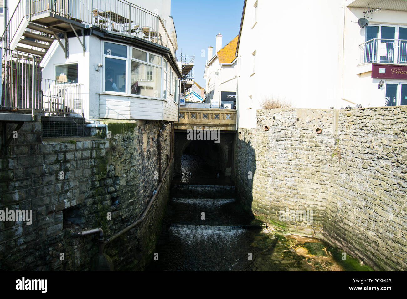 Lime Regis arch water stream canal house houses stone stones wall high ...