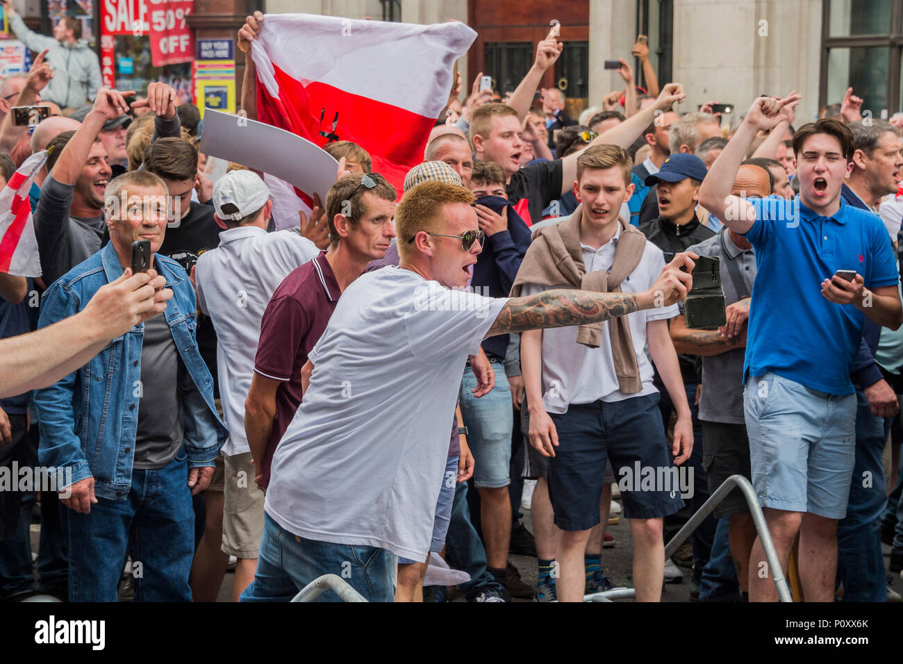 London, UK. 9th June 2018. Supporters attack a small police cordon and ...