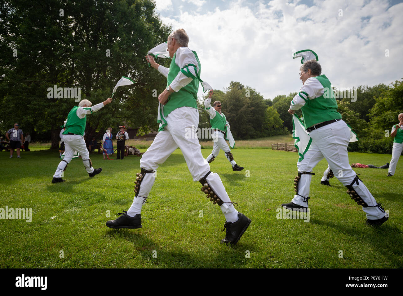 Morris dancers dressed in traditional costumes wave handkerchiefs in ...