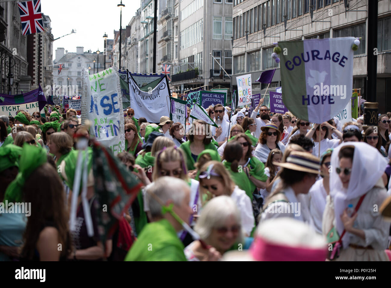 Women marching through London to mark 100 years since the first British ...