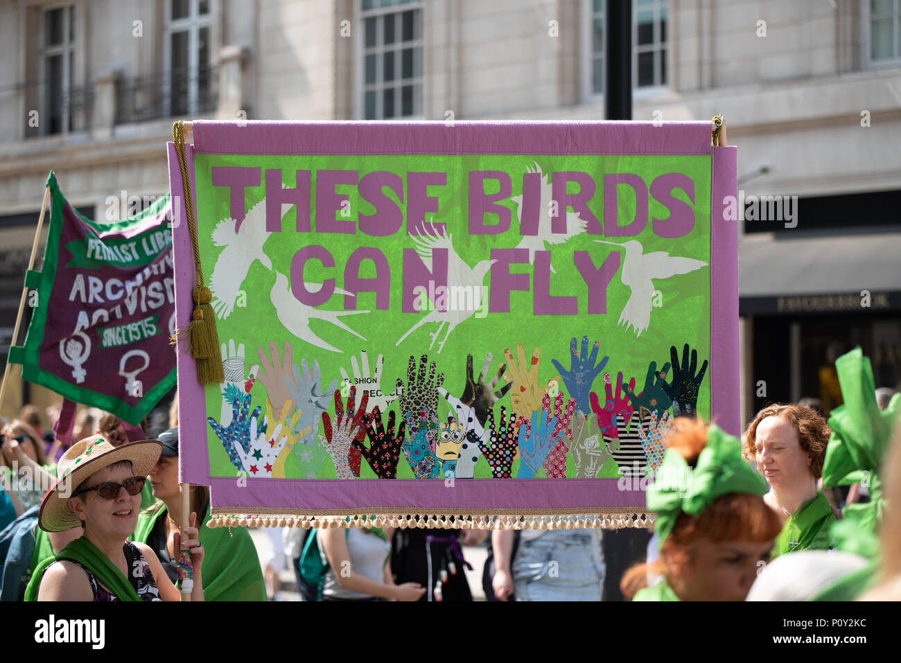 Women marching through London to mark 100 years since the first British ...