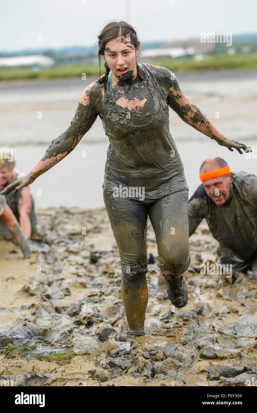 Maldon Mud Race competitor in the slimy mud of the River Chelmer, Essex ...