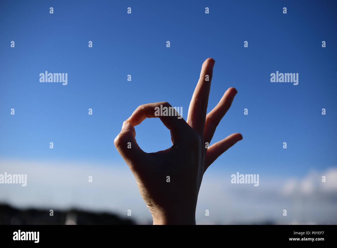 Female hands making OK sign in the sky Stock Photo - Alamy