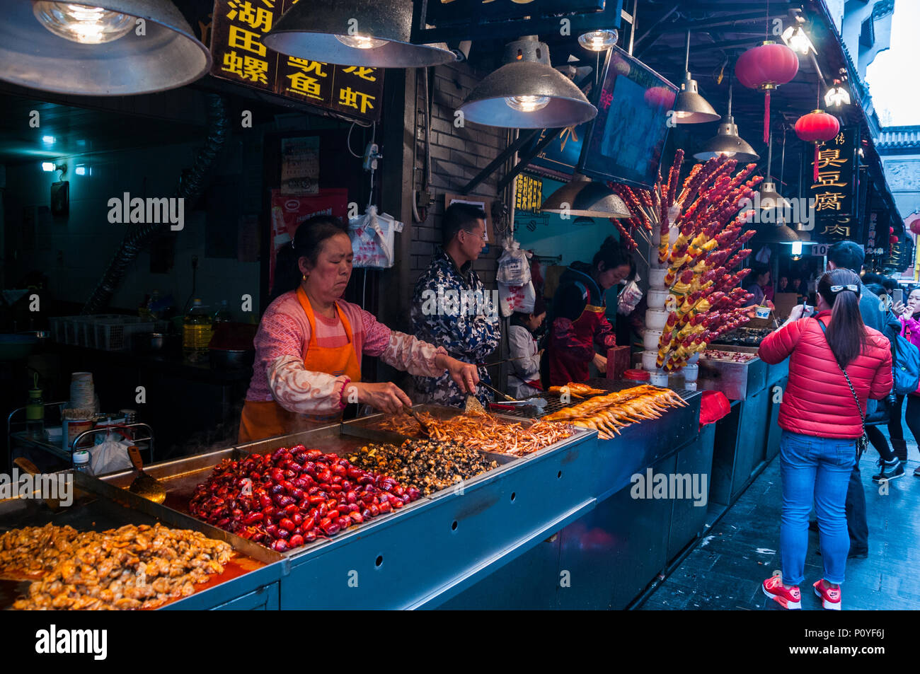 Stall holders cooking food in Wuhan's Hubu Alley food street, China ...