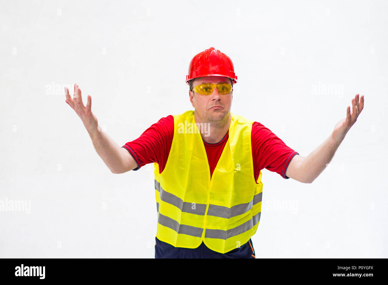 Confused factory worker expressing misunderstanding looking up in his ...