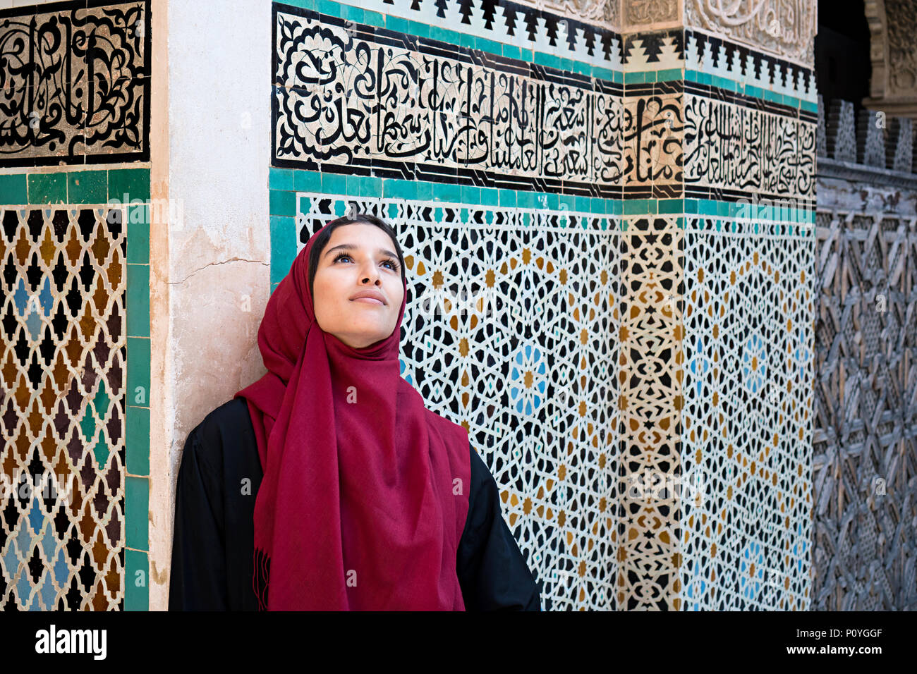 Muslim woman in traditional clothing with red hijab and black dress in ...
