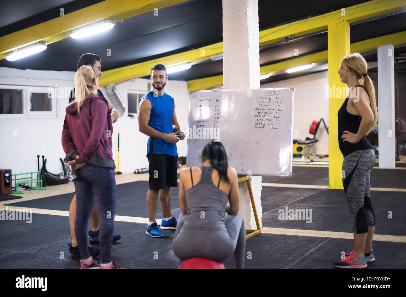Training course.group of young athletes getting instructions from ...