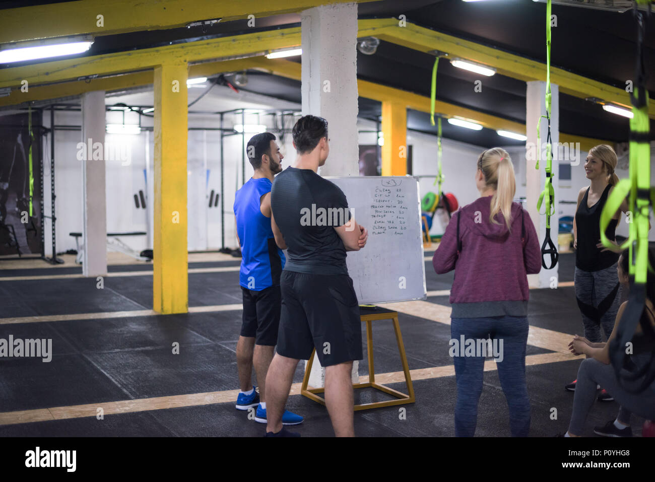 Training course.group of young athletes getting instructions from ...
