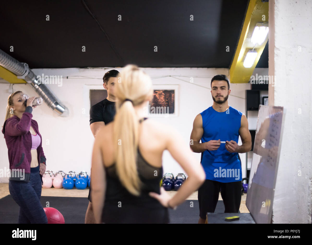 Training course.group of young athletes getting instructions from ...