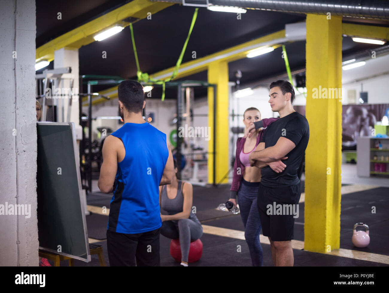 Training course.group of young athletes getting instructions from ...