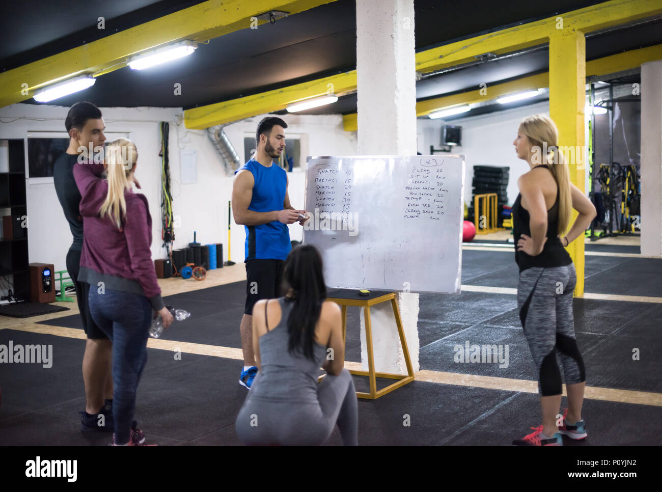 Training course.group of young athletes getting instructions from ...